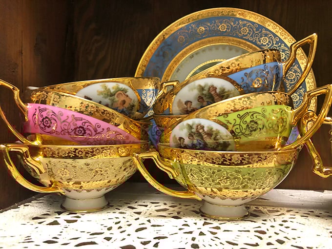 Gilded teacups fit for royalty! These hand-painted beauties have survived decades of afternoon teas to arrive at their glass-shelved retirement home.