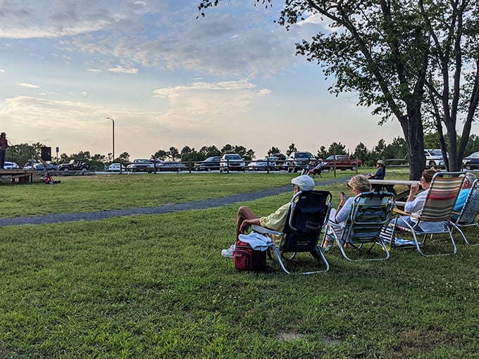 The universal language of relaxation: lawn chairs, open skies, and the unspoken agreement to put phones away for just one blessed evening.