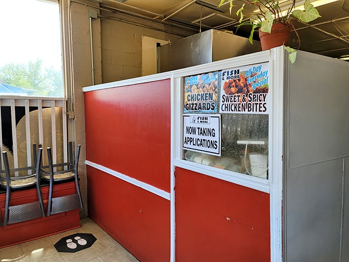 The ordering window—where dreams and hunger meet reality. Those signs promise chicken gizzards that might just change your mind about offal.