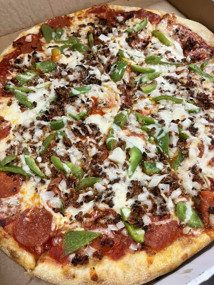 Green peppers, ground beef, and pepperoni living harmoniously on one pie. If only world peace could be achieved as easily as pizza topping harmony.