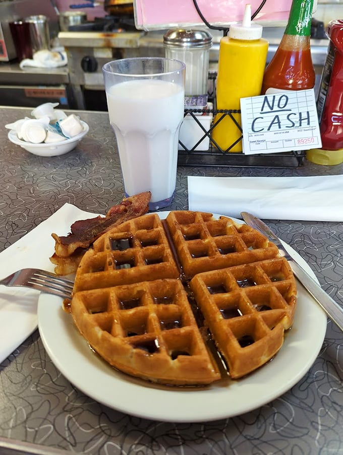 Golden waffle perfection with a side of bacon – proof that sometimes the simplest pleasures are the ones worth crossing state lines for.