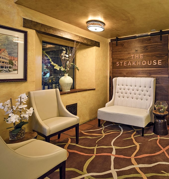 The elegant waiting area says "we take our steaks seriously" while the tufted chairs whisper "but we're not stuffy about it."