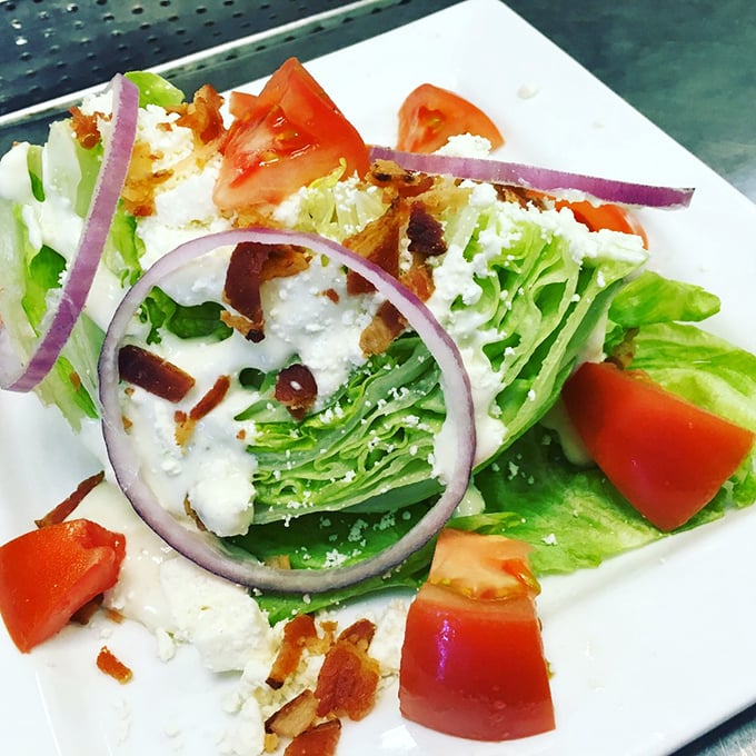 A wedge salad that doesn't mess around – crisp iceberg, bacon bits, and blue cheese bringing the holy trinity of salad satisfaction.
