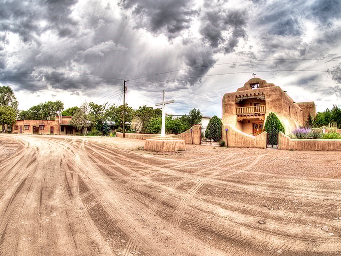 Abiquiú's adobe church stands eternal against desert cliffs, a testament to faith and southwestern architectural beauty.