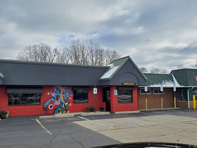 Memphis-inspired murals and bold red paint make this Fenton barbecue spot impossible to miss.
