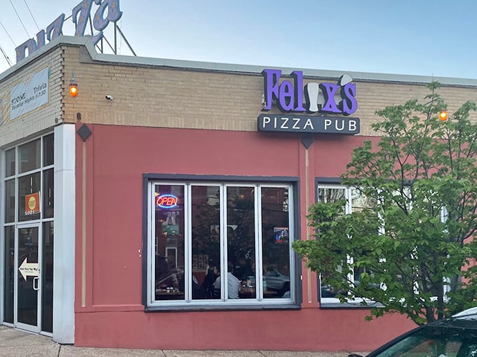 A purple sign and bold facade make Felix’s Pizza Pub stand out, promising good vibes and even better pies inside.