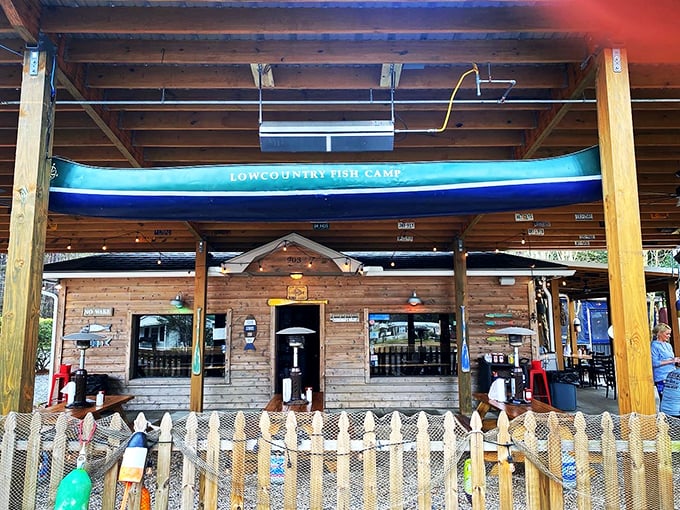 Rustic wooden beams and that "Lowcountry Fish Camp" sign promise authentic flavors worth the inland drive.