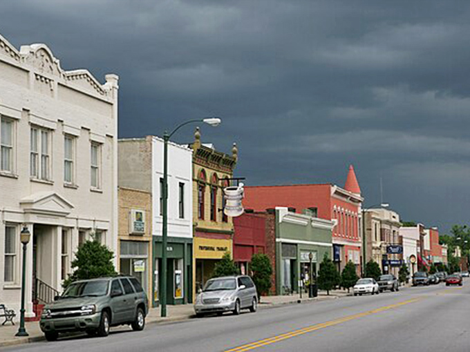 Main Street stretches ahead like a promise – affordable living and genuine community await around corner.