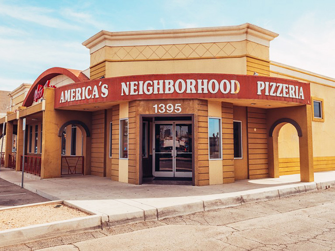 The sunshine-yellow building with "America's Neighborhood Pizzeria" isn't just a sign—it's a promise kept.