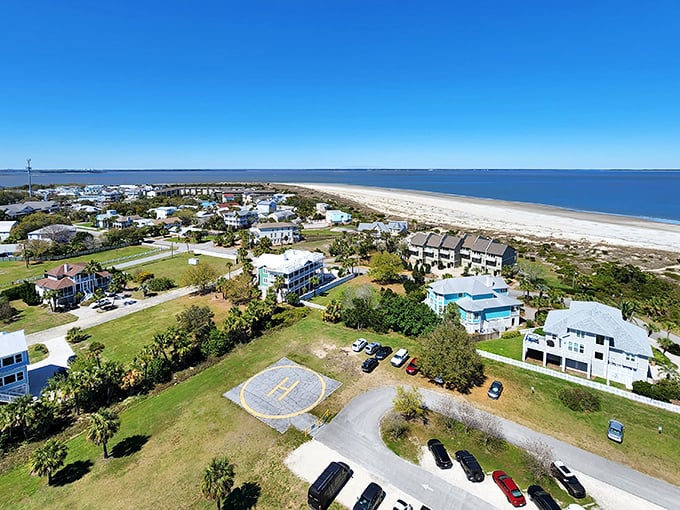 Tybee's pastel paradise from above! Beach homes cluster like colorful seashells around a helipad—because even paradise needs an emergency landing spot.