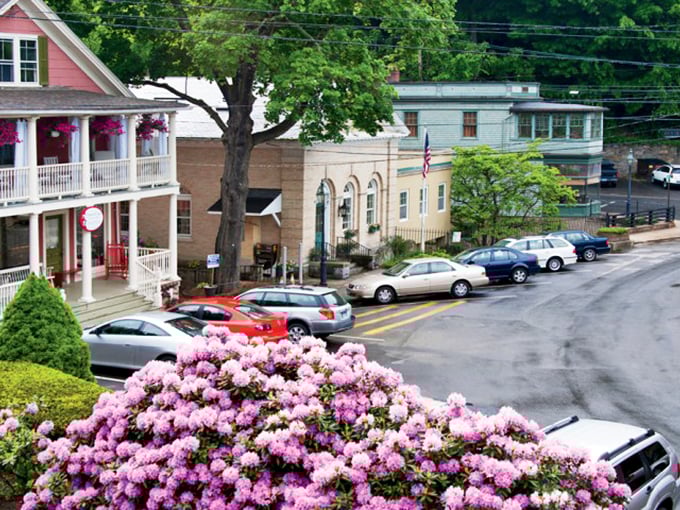 Pink rhododendrons explode like nature's confetti, adding joyful color to this already charming slice of Connecticut small-town life.