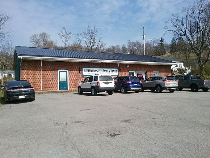 Cars lined up outside Lightburns on a sunny day. When the parking lot's this full in a small town, you know the food's worth waiting for.