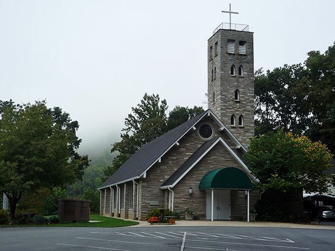 Maggie Valley's stone church stands as a testament to mountain craftsmanship, with misty peaks creating a heavenly backdrop.