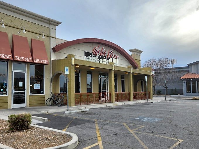 That curved red awning isn't architectural flair—it's a smile anticipating your pizza happiness.