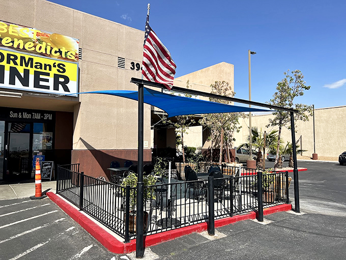 The patriotic flag and outdoor seating create the perfect setting for all-American breakfast conversations.