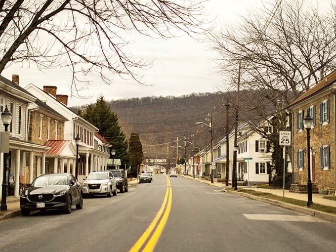 Small-town storefronts nestle against hillsides, creating a peaceful setting where nature and community live in perfect harmony together.