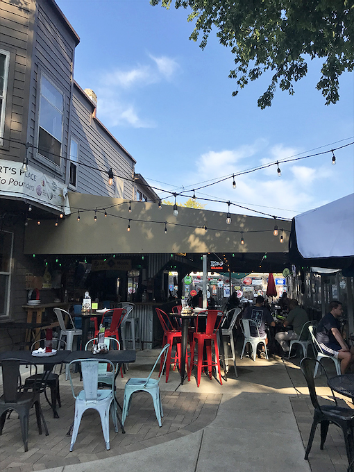 The year-round heated patio offers al fresco dining under string lights, where summer evenings stretch as long as the cheese pulls.
